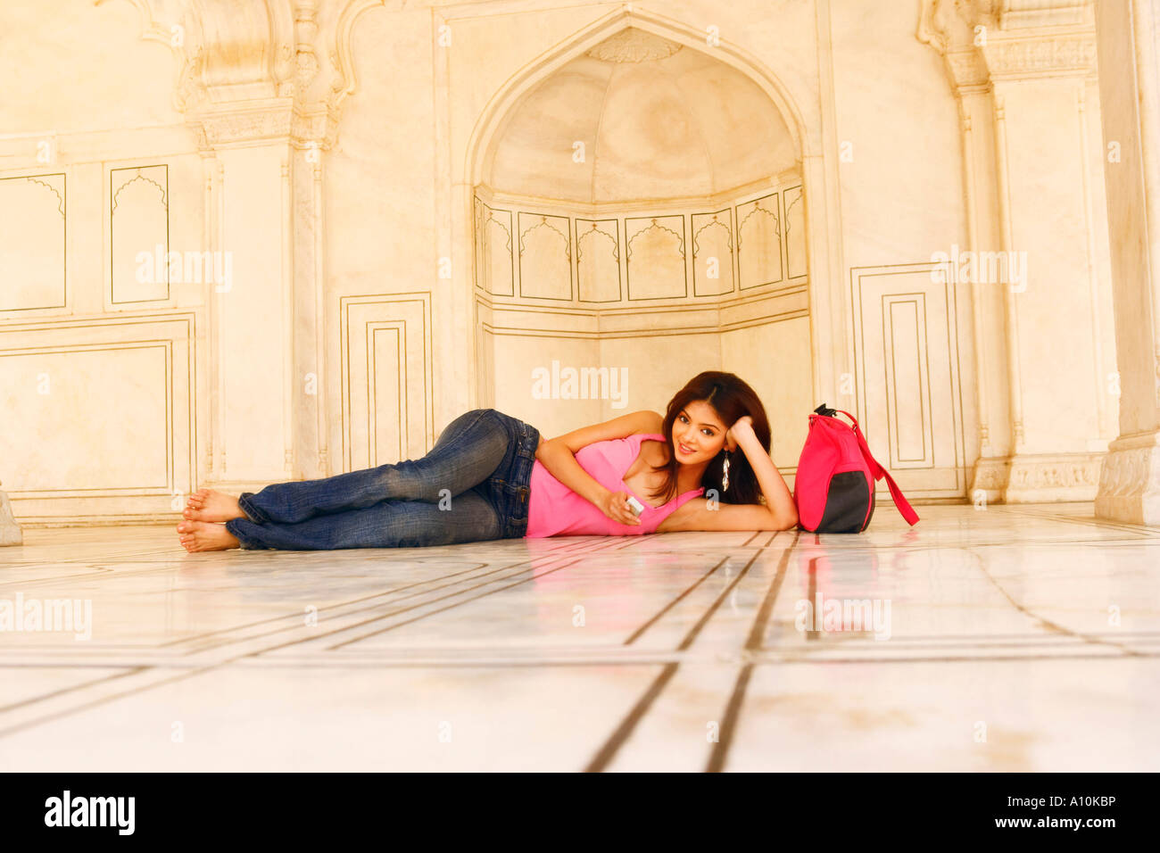 Portrait of a young woman lying on the floor Stock Photo - Alamy