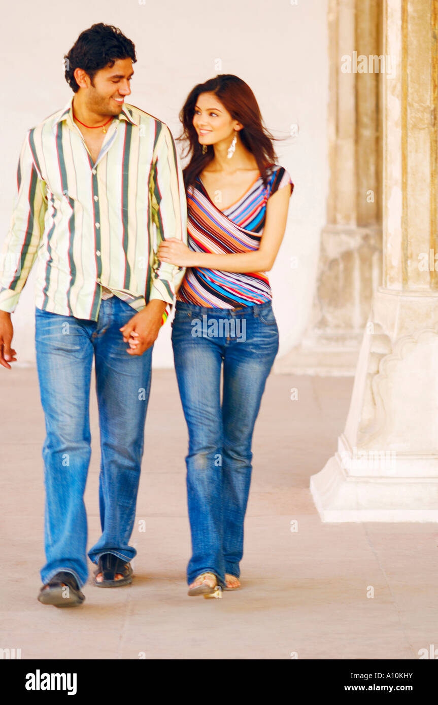 Young couple walking side by side Stock Photo - Alamy