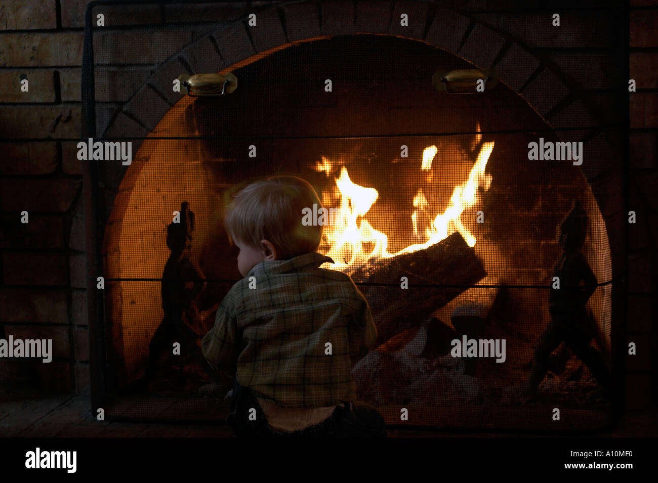 toddler playing in front of fire fireplace caucasians white families ...