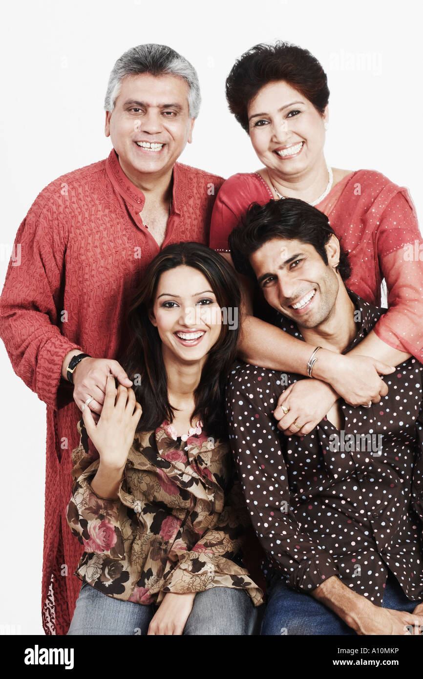 Portrait of parents and their two children smiling Stock Photo - Alamy