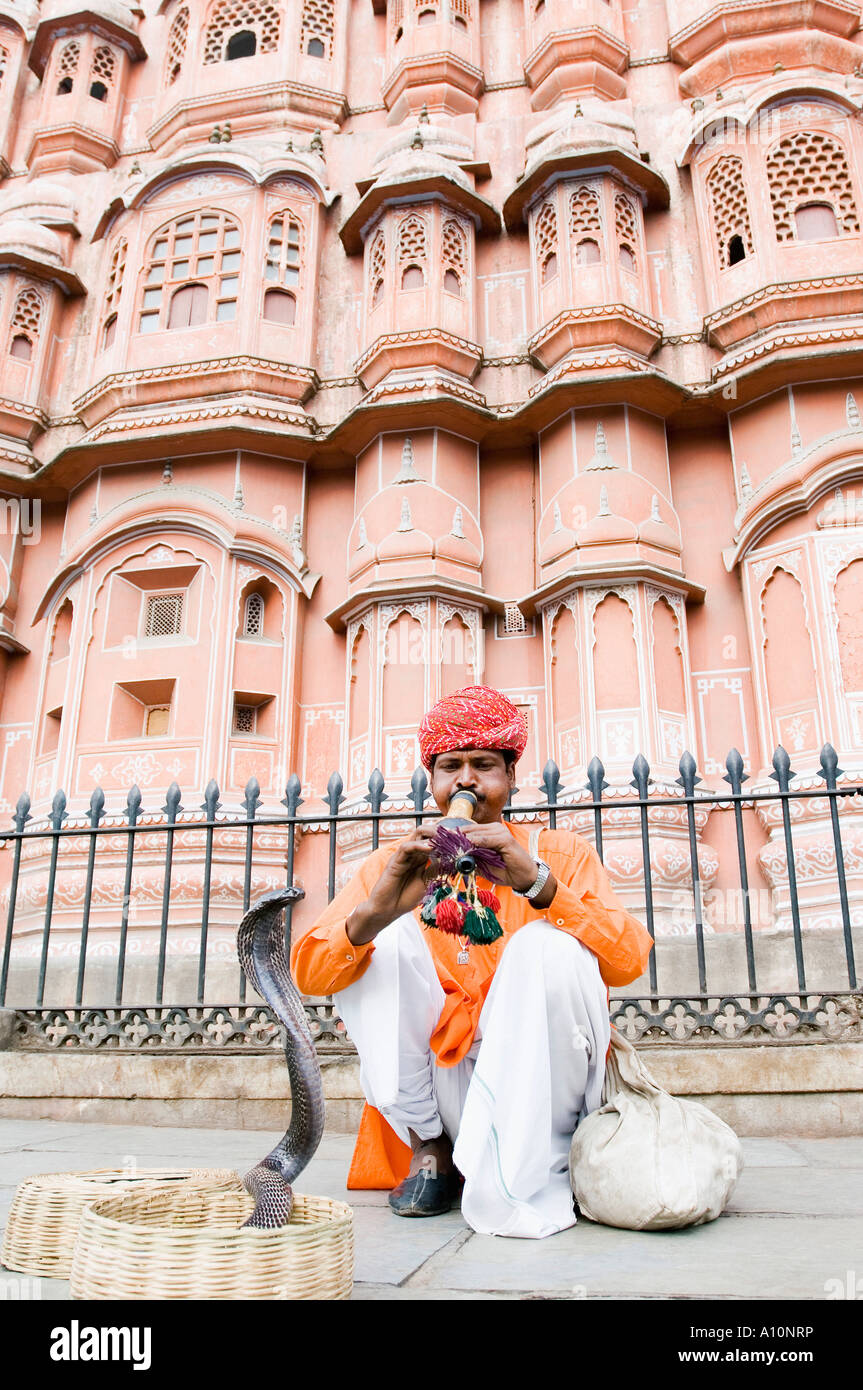 Snake charmer playing a flute in front of a palace, Hawa Mahal, Jaipur ...