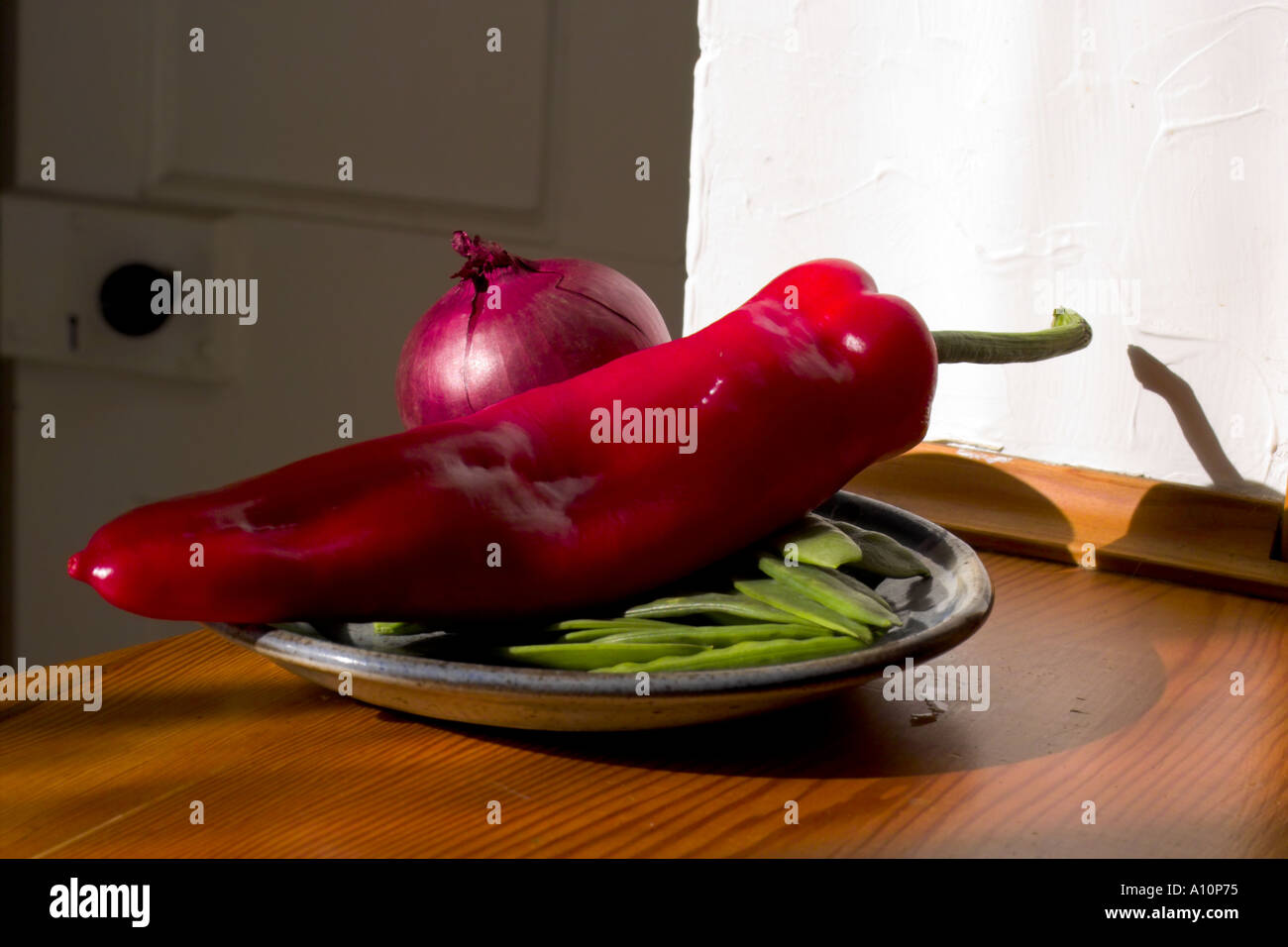 Red long pepper red onion and mange tout peas Stock Photo - Alamy