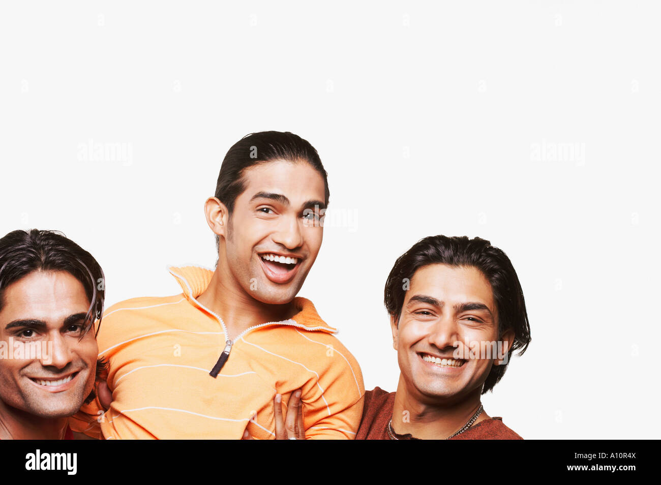 Portrait of three young men smiling Stock Photo - Alamy