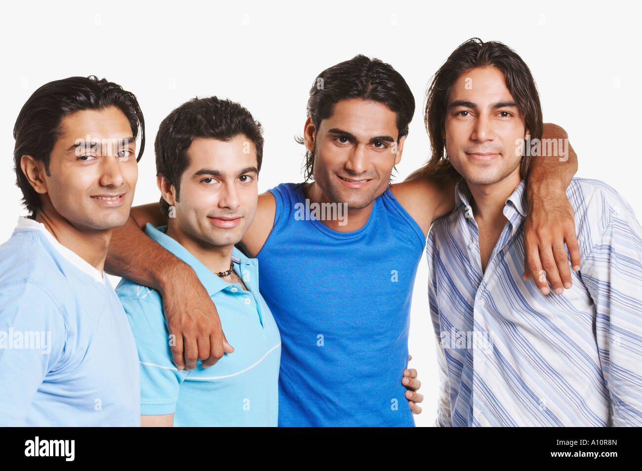 Portrait of four young men smiling Stock Photo - Alamy