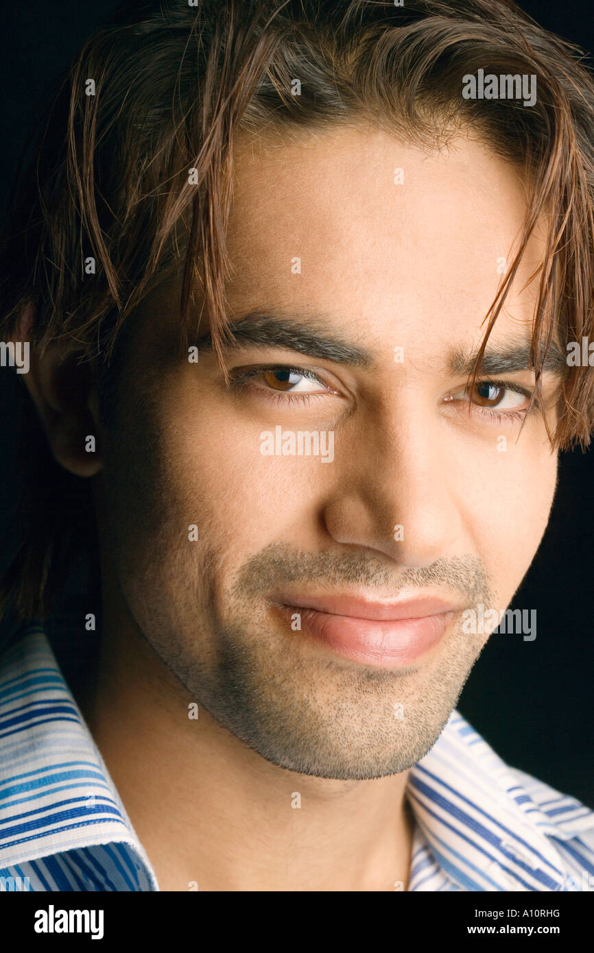 Portrait of a young man smirking Stock Photo - Alamy