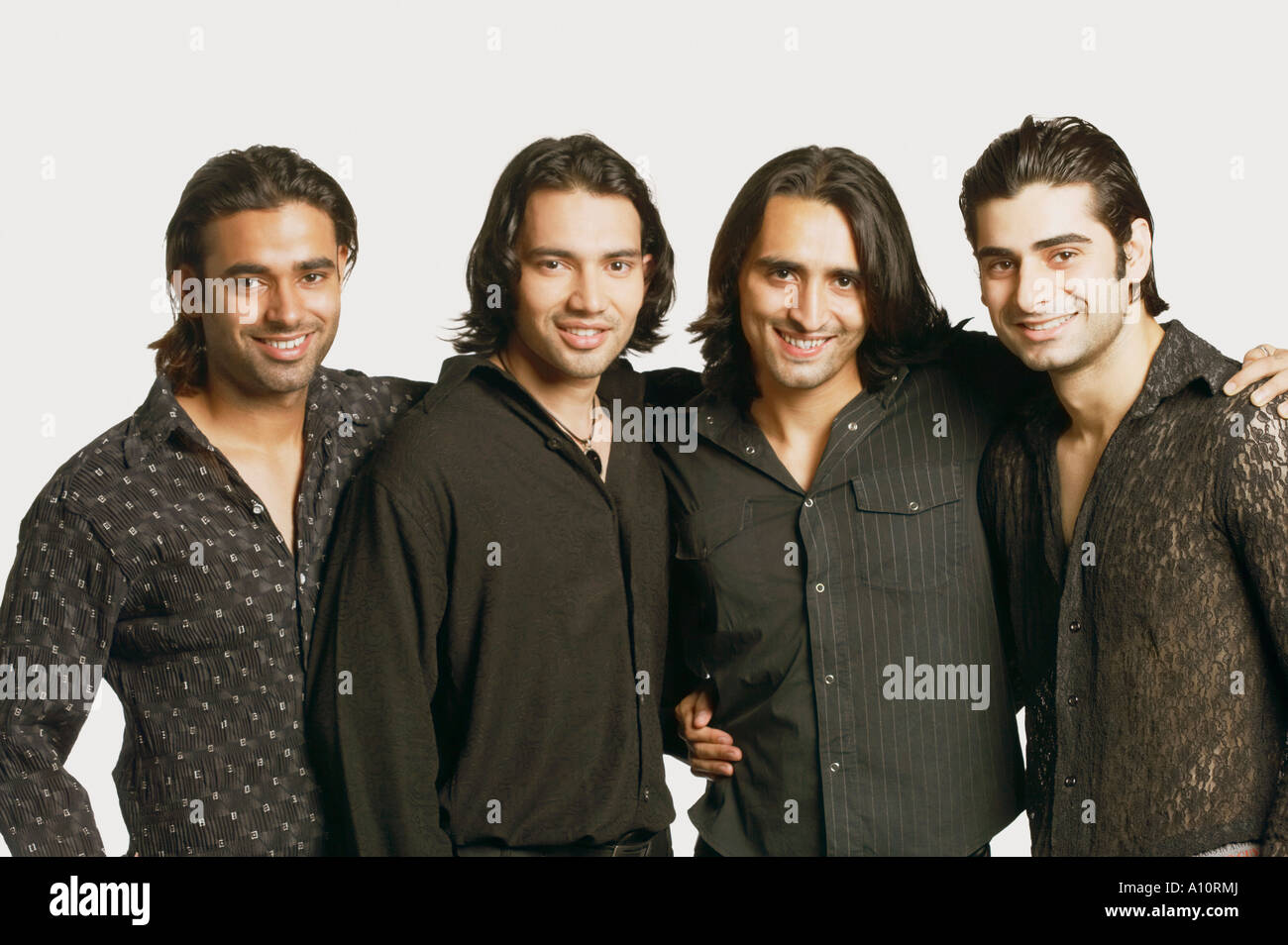 Portrait of four young men smiling Stock Photo - Alamy