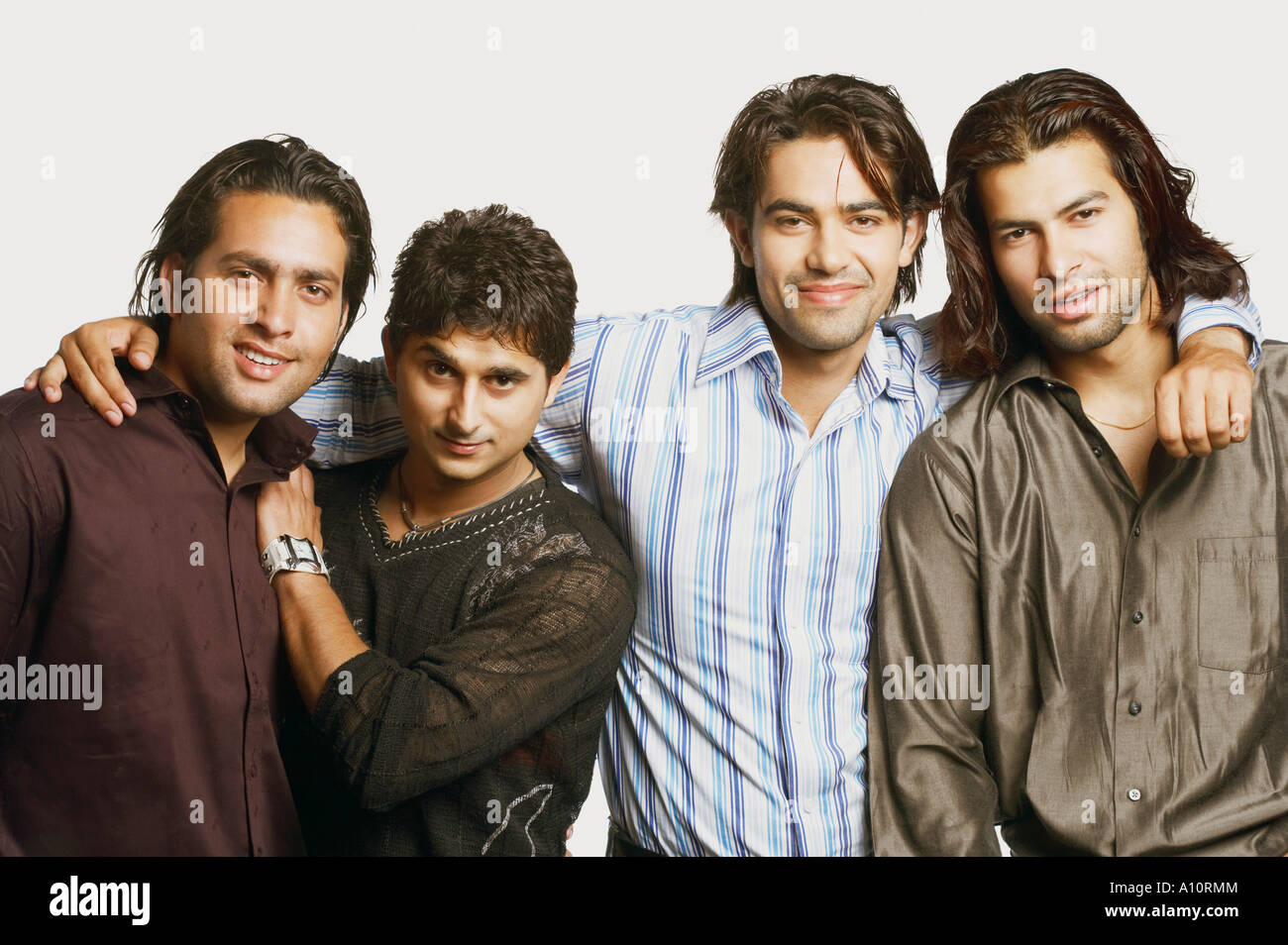 Portrait of four young men with their arms around each other Stock ...