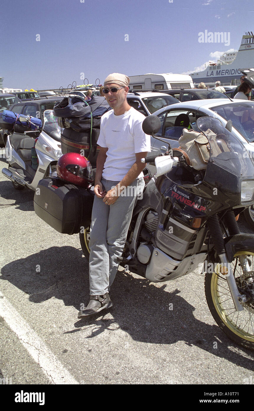 Man standing in front of motorcycle Stock Photo - Alamy