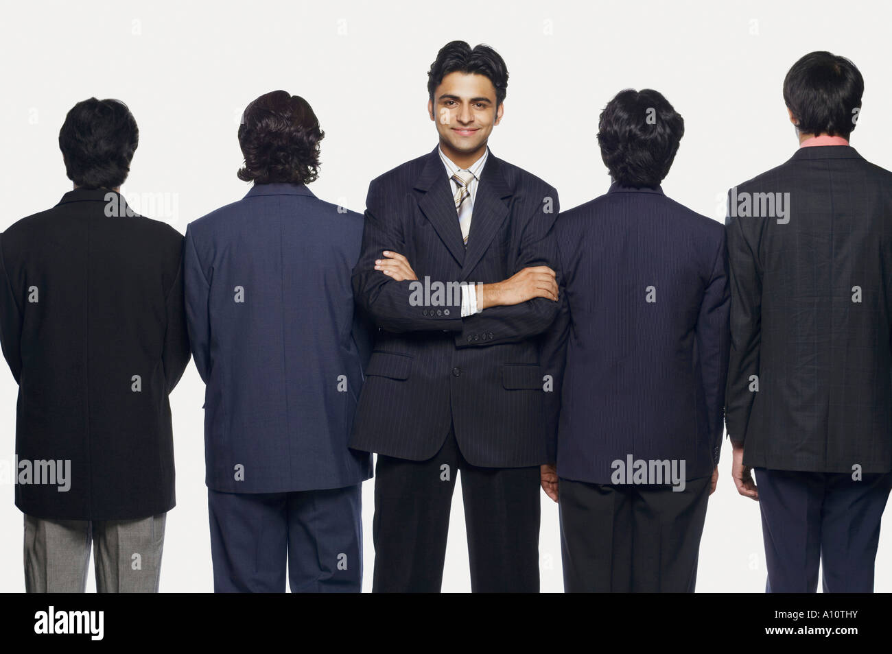 Portrait of a businessman standing with his four colleagues in opposite ...
