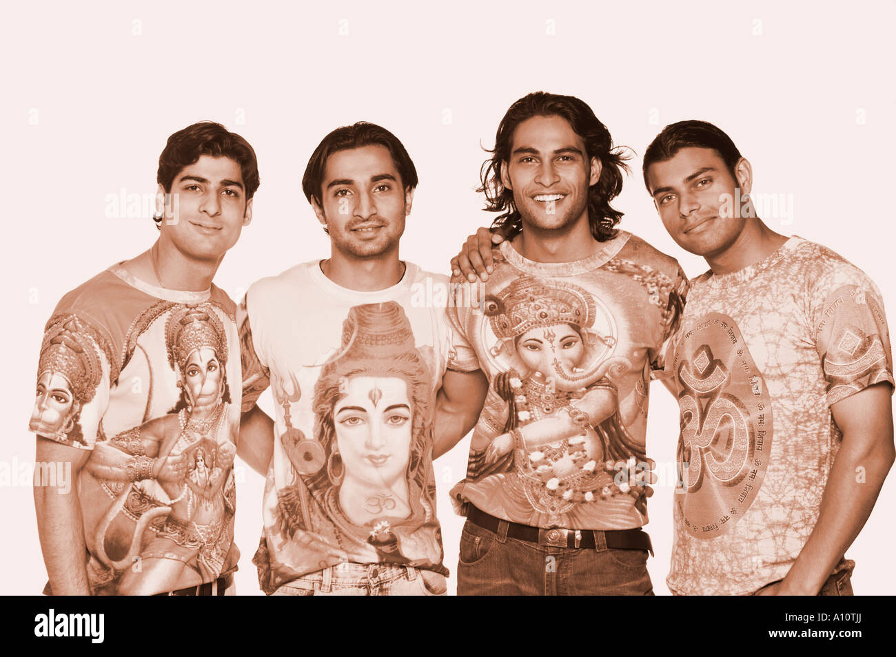 Portrait of four young men standing together and smiling Stock Photo ...