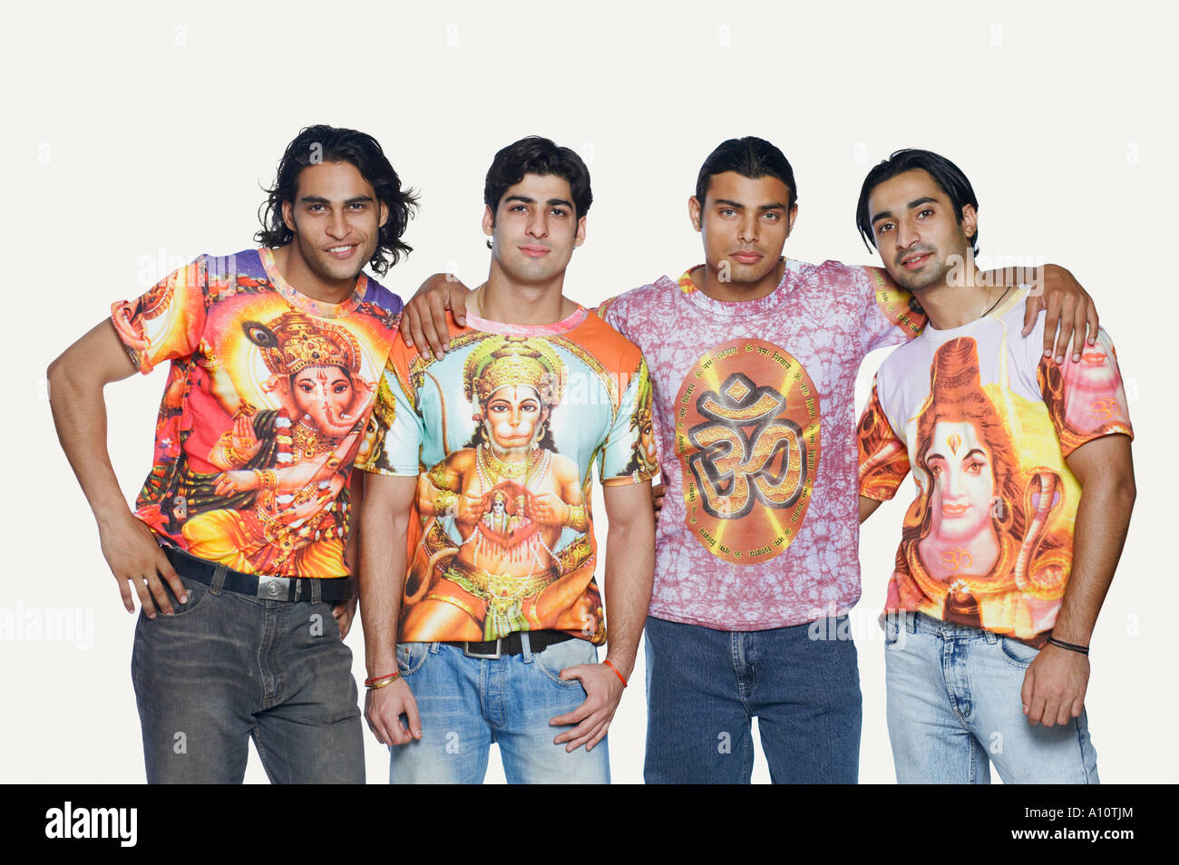 Portrait of four young men standing together and smiling Stock Photo ...