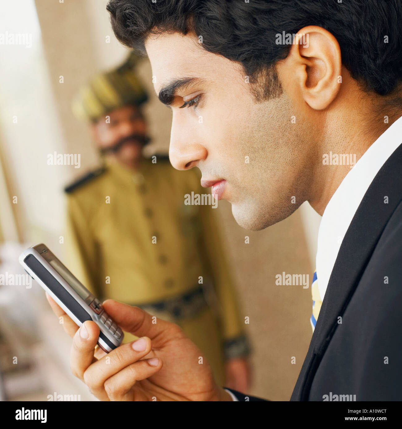 Side profile of a businessman using a mobile phone Stock Photo - Alamy