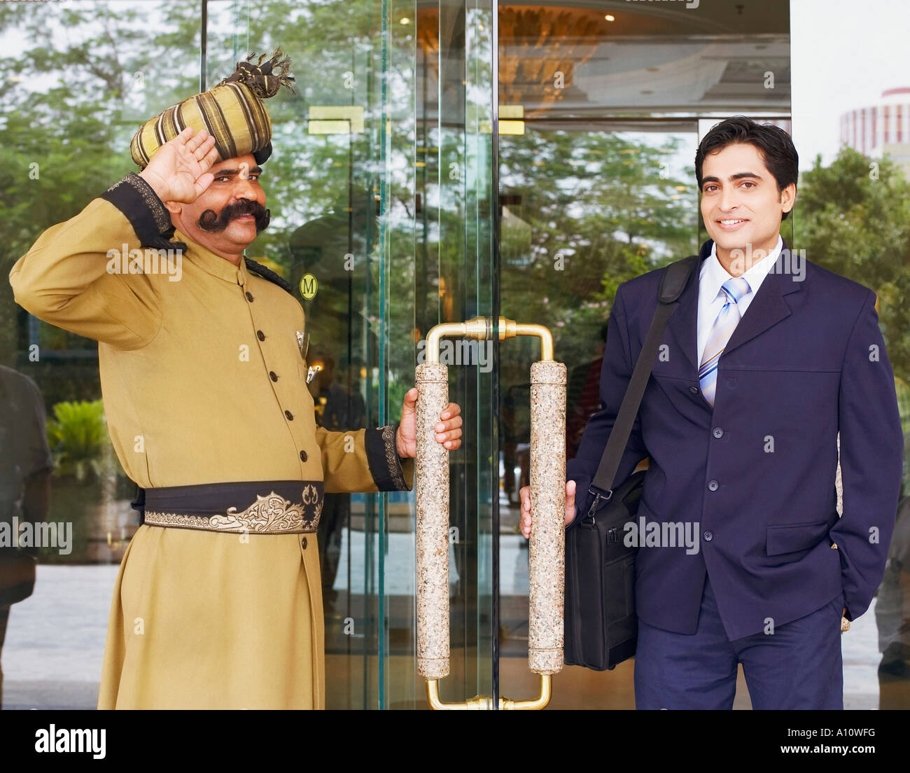 Portrait of a security guard saluting a businessman Stock Photo - Alamy