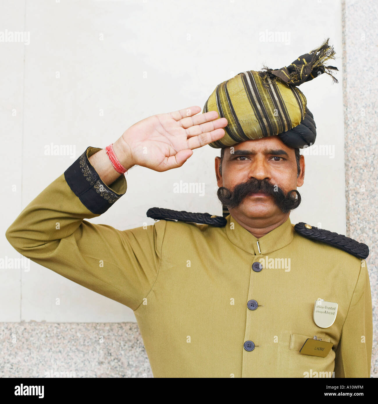 Portrait of a security guard saluting Stock Photo - Alamy