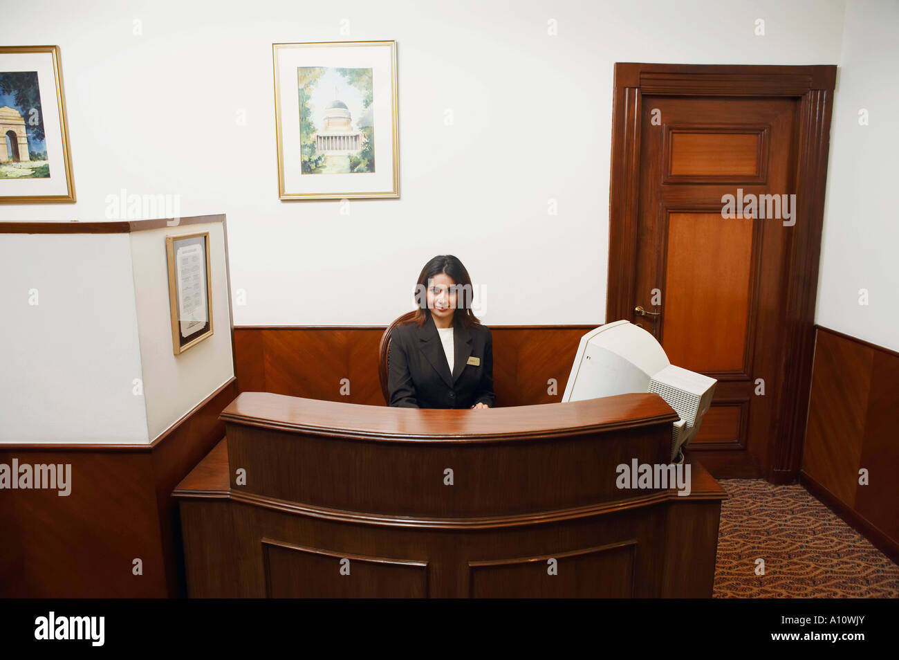 Young female receptionist in formal hi-res stock photography and images ...
