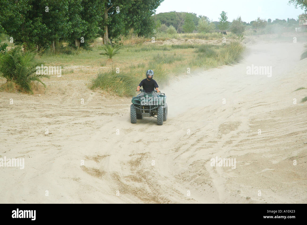 Boy driving with quad on country road Stock Photo - Alamy