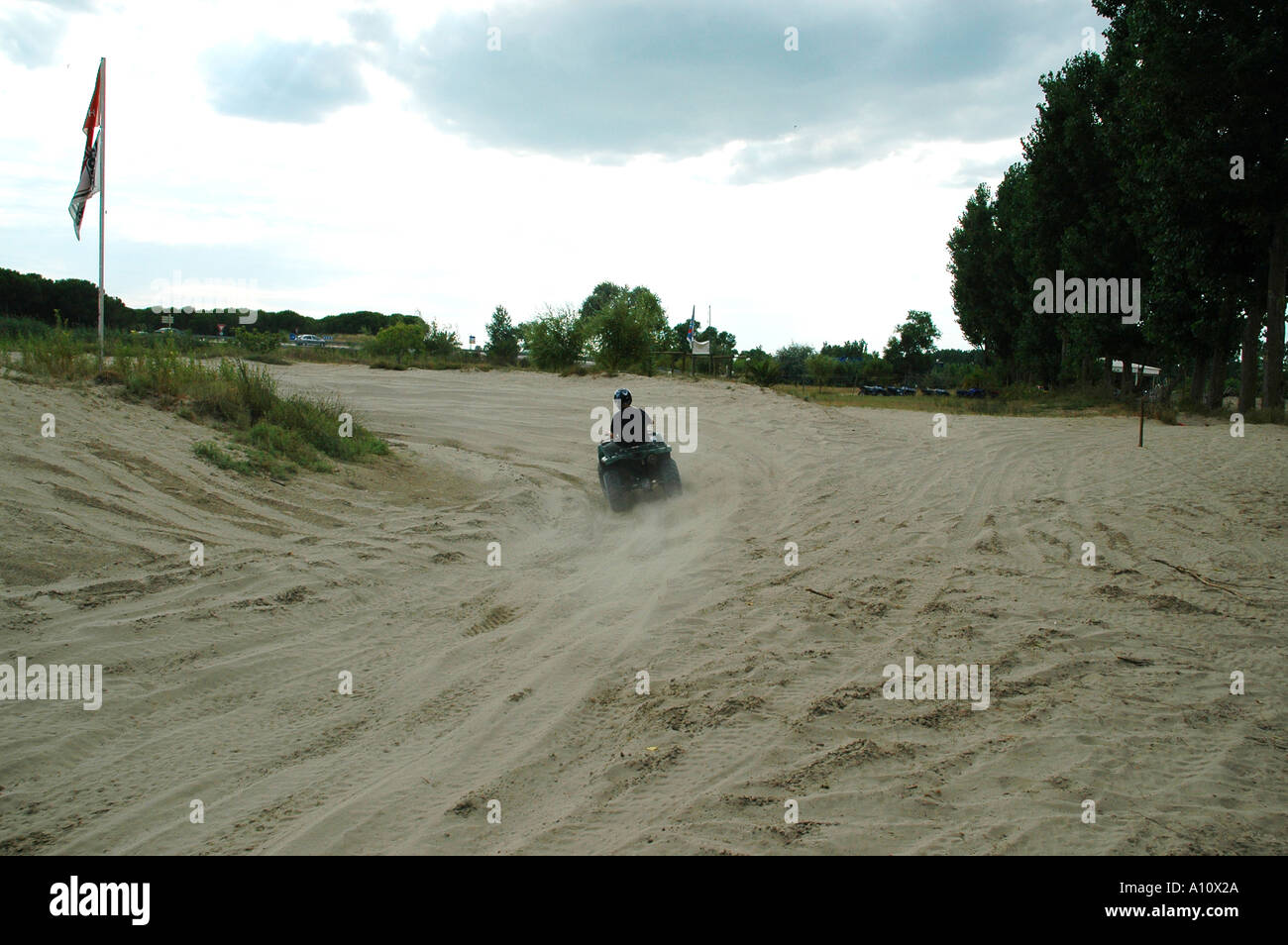 Boy driving with quad on country road Stock Photo - Alamy