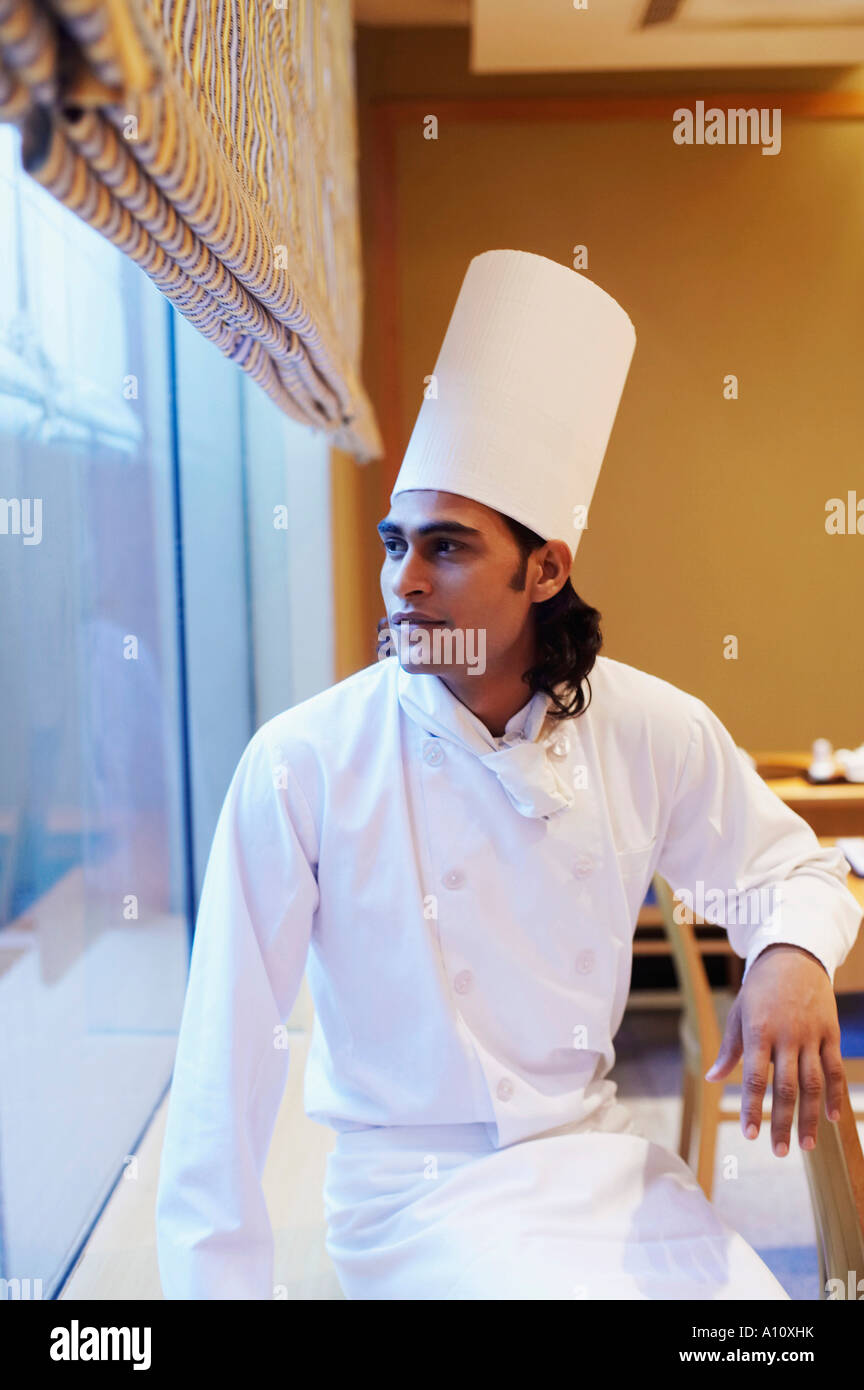 Chef sitting by a window Stock Photo - Alamy