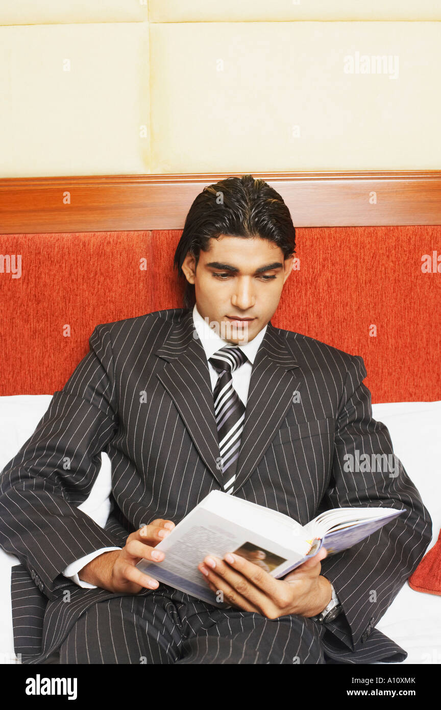 Indian man book reading reclining hi-res stock photography and images ...