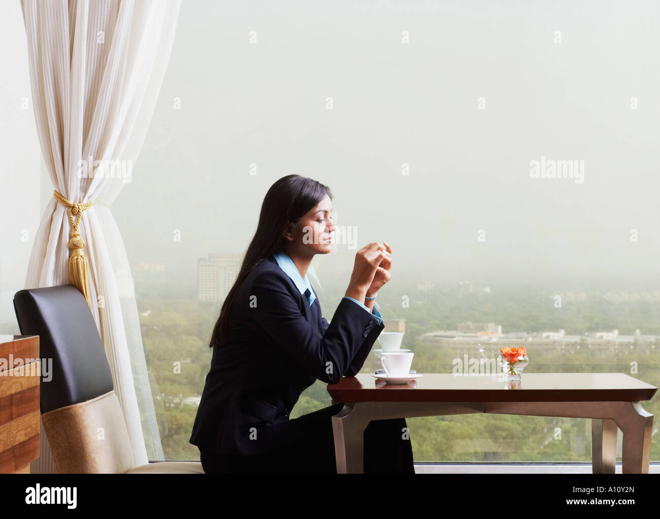 Side profile of a businesswoman sitting in an office Stock Photo - Alamy