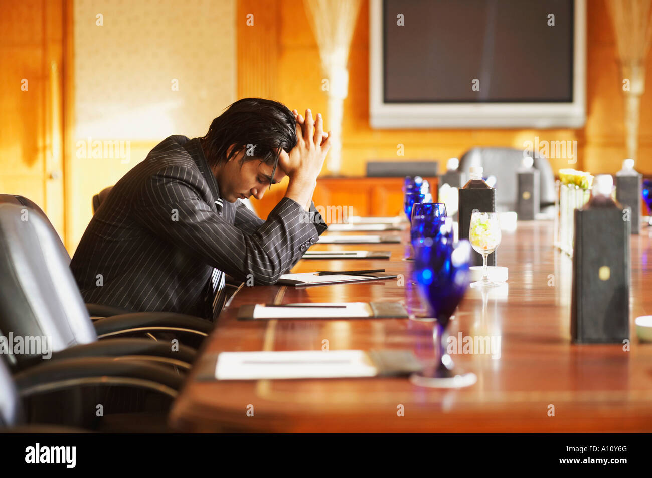 Side profile of a businessman relaxing in a conference room Stock Photo ...