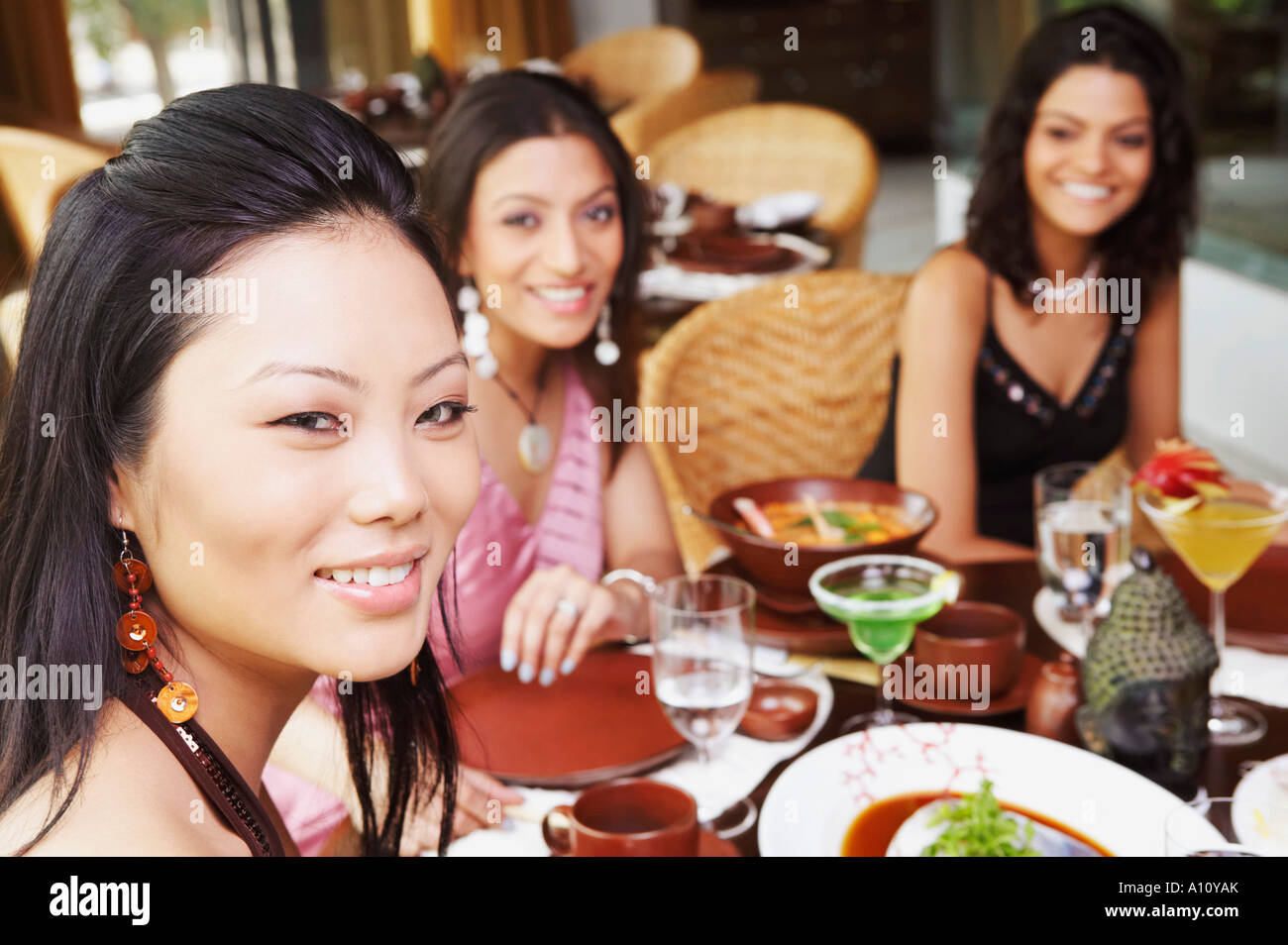 Three young women dining in a restaurant Stock Photo - Alamy