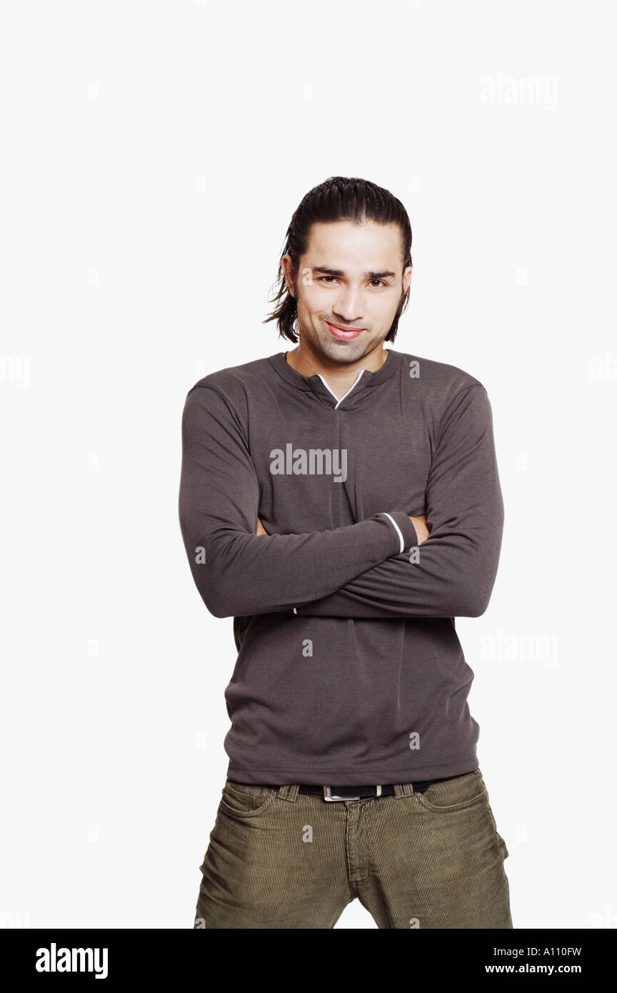 Portrait of a young man standing with his arms crossed Stock Photo - Alamy
