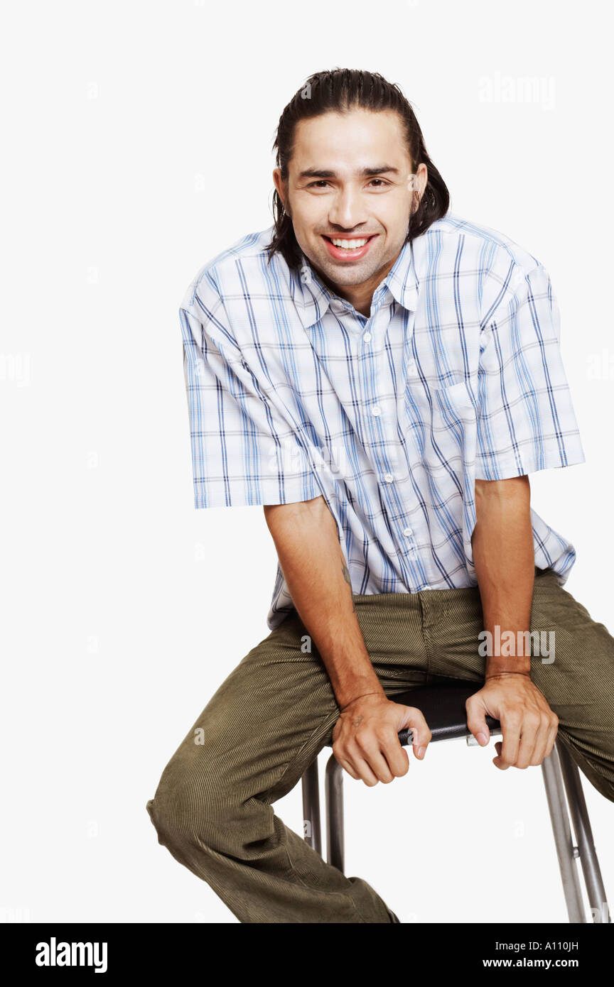 Black man sitting on a stool hi-res stock photography and images - Alamy