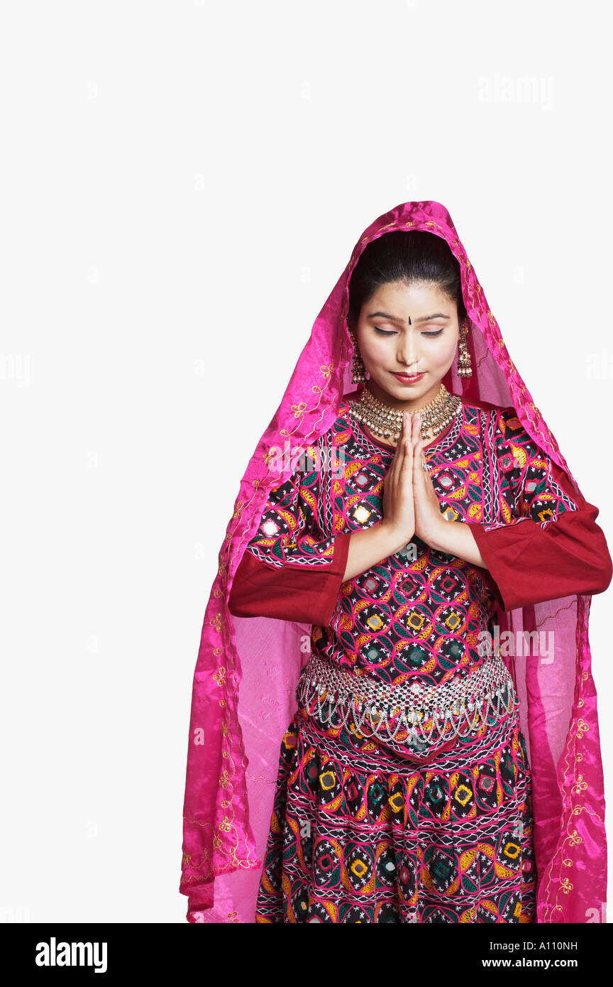 Close-up of a young woman standing in a prayer position Stock Photo - Alamy