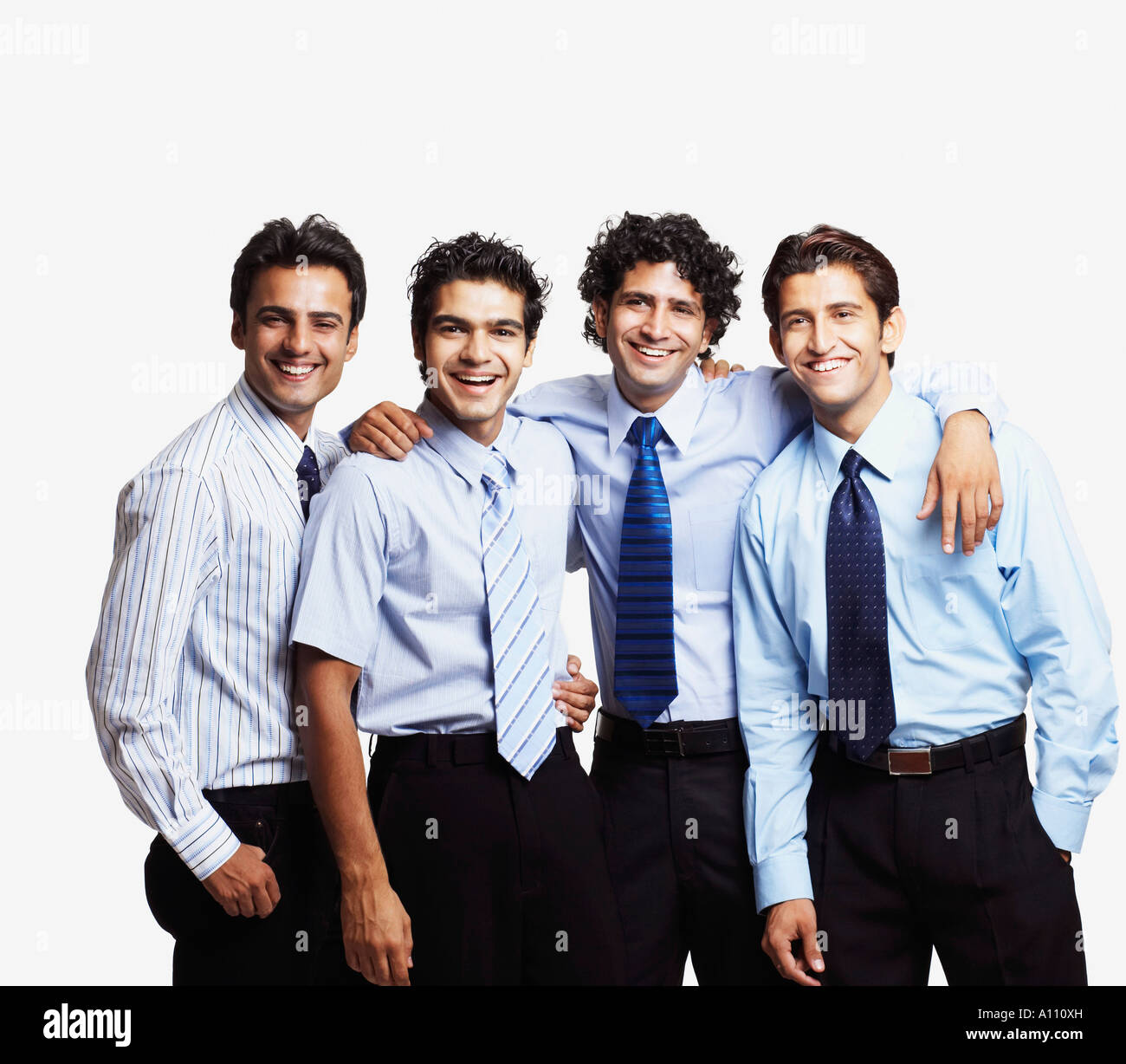 Portrait of four businessmen standing together and smiling Stock Photo ...