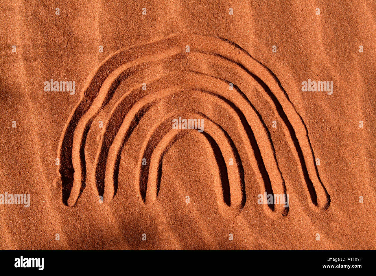 Drawing of a gunya, a traditional aboriginal shelter, in red sand near ...