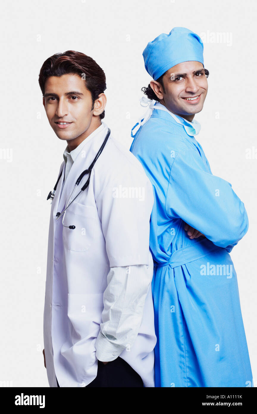 Portrait of two male doctors standing back to back Stock Photo - Alamy