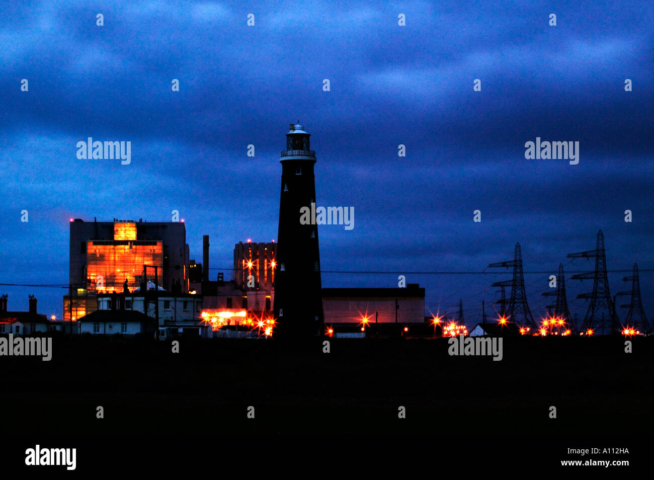 Orange glowing interior of nuclear power station and the old lighthouse ...