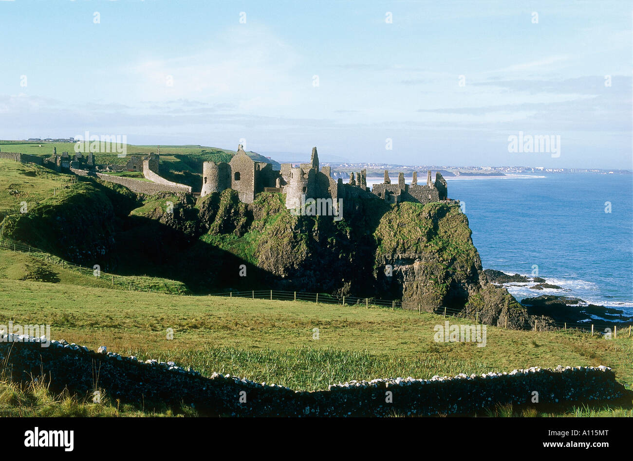 The town of Portrush provides a backdrop to the outcrop ruins of ...
