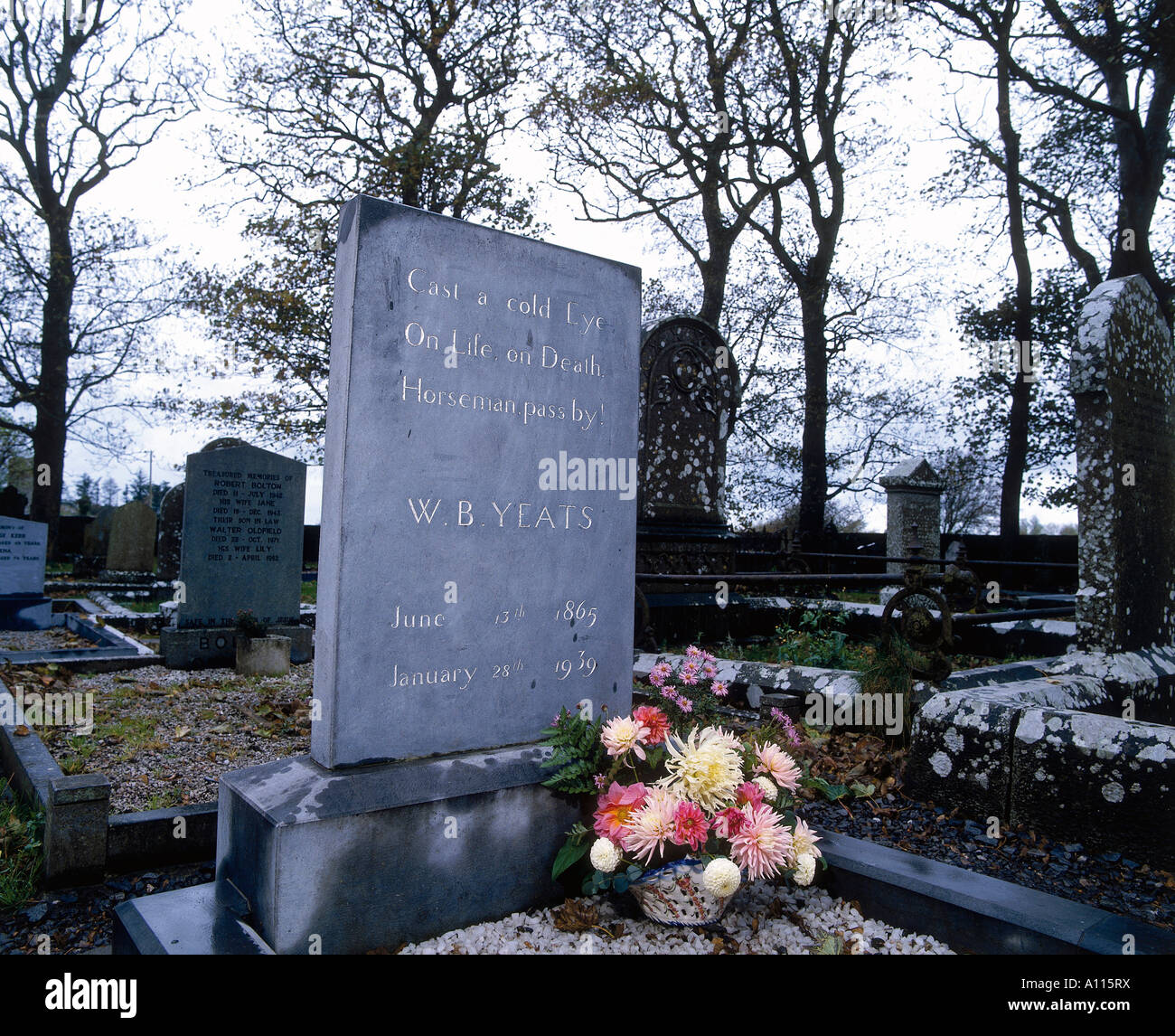 Flowers in front of the stone marking the grave of the poet WB Yeats ...