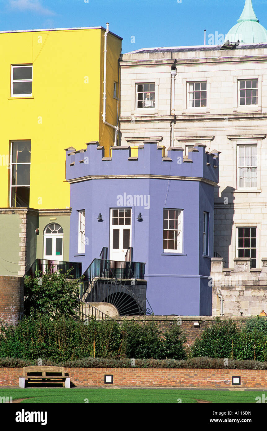 A dark blue castellated building in Dublin next to a yellow building ...