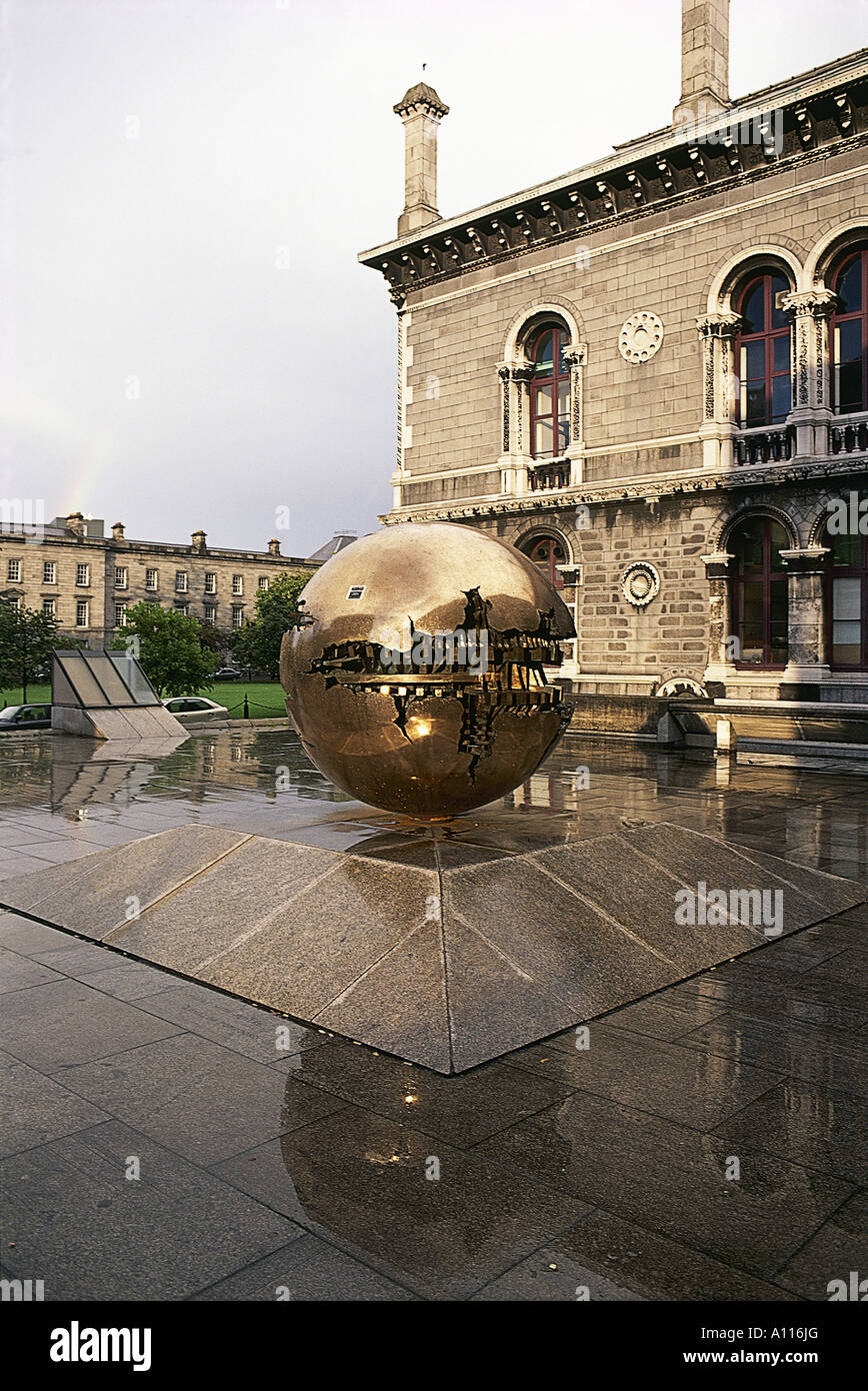 The golden globe sculpture stands outside the Trinity College library ...