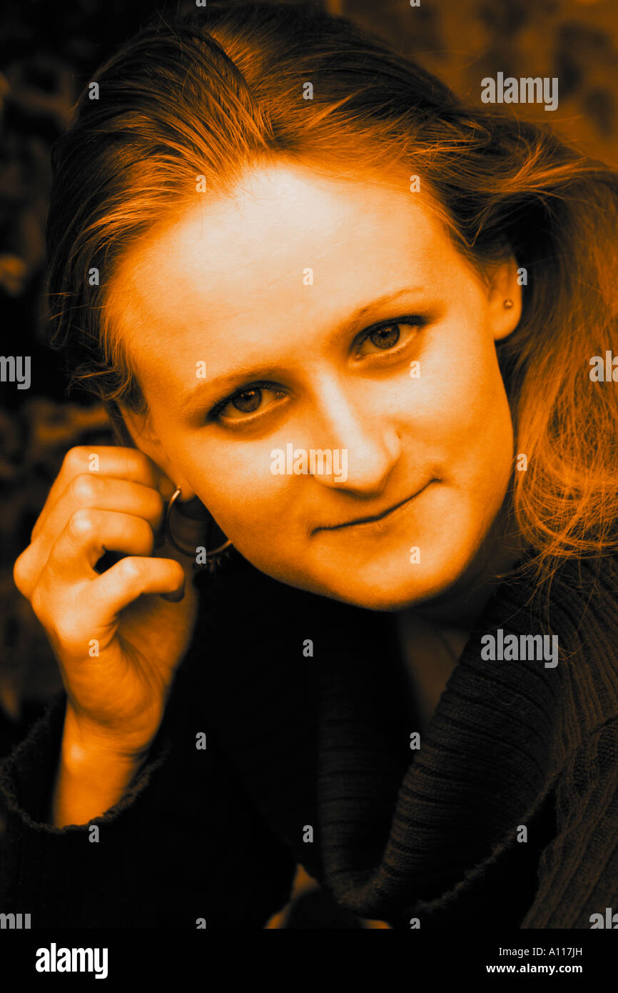 a portrait of a pretty young woman with a ghost of smile upon her face ...