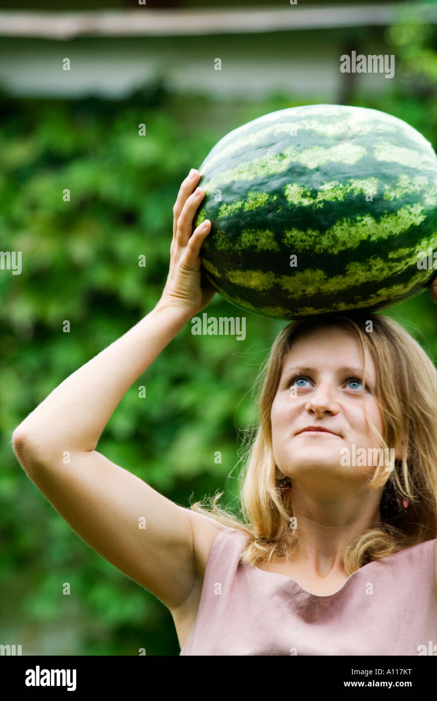 a portrait of a pretty girl with a big watermelon in her hands Stock ...
