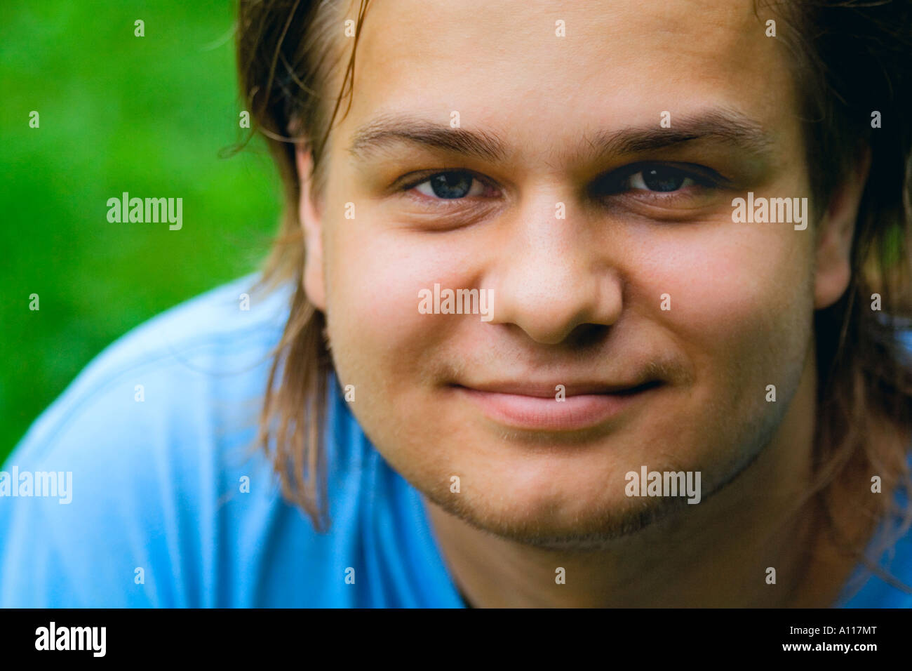 a portrait of a young man with a pleased smile upon his face Stock ...