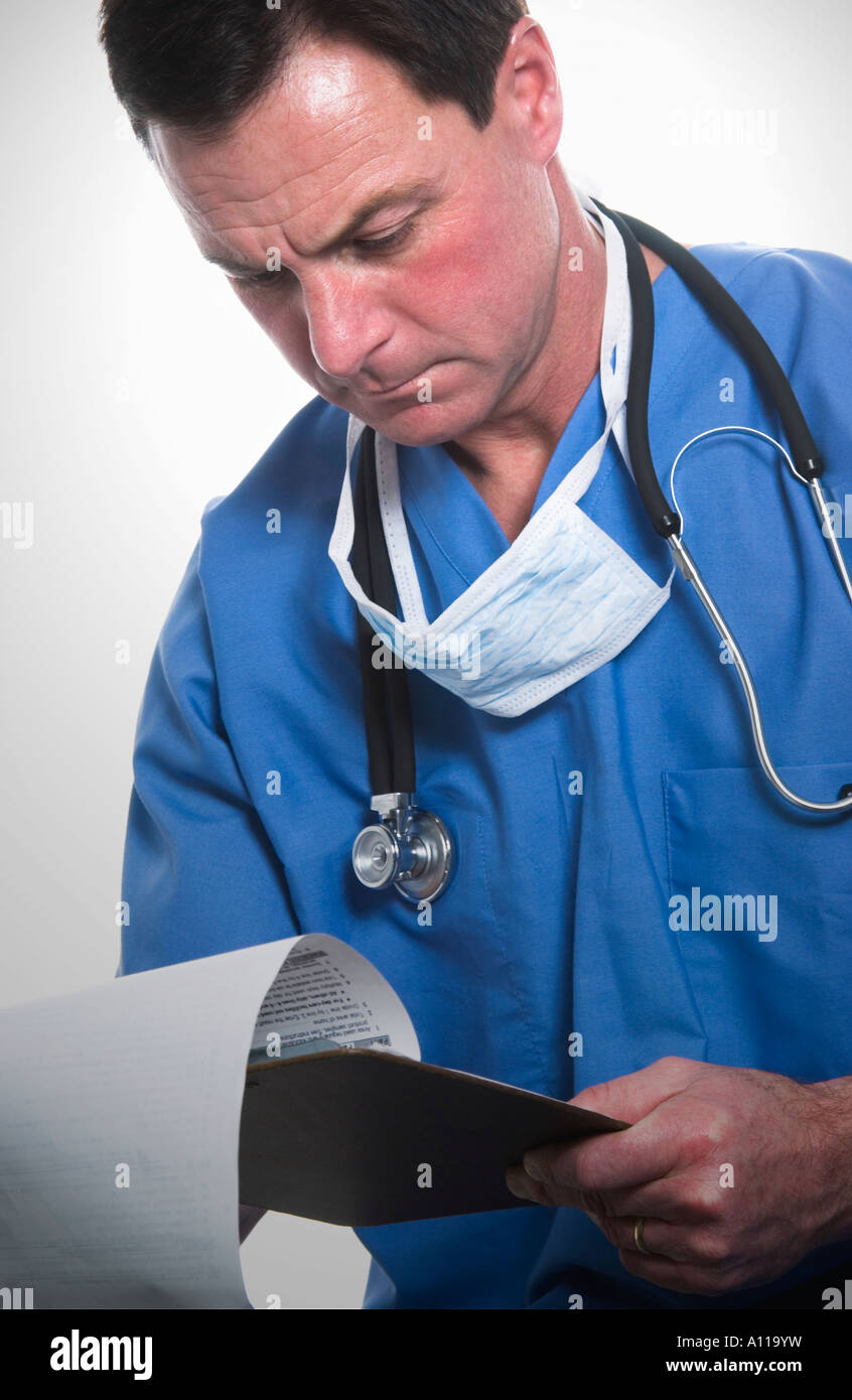 Male doctor writing on patient chart Stock Photo - Alamy