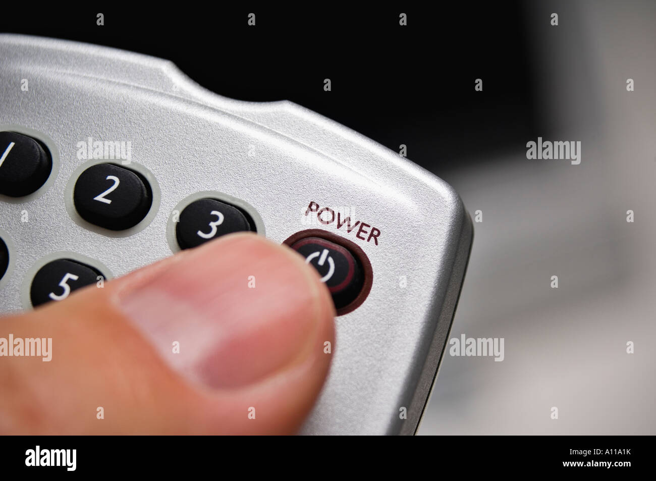 Man changing TV channel with remote control Stock Photo - Alamy