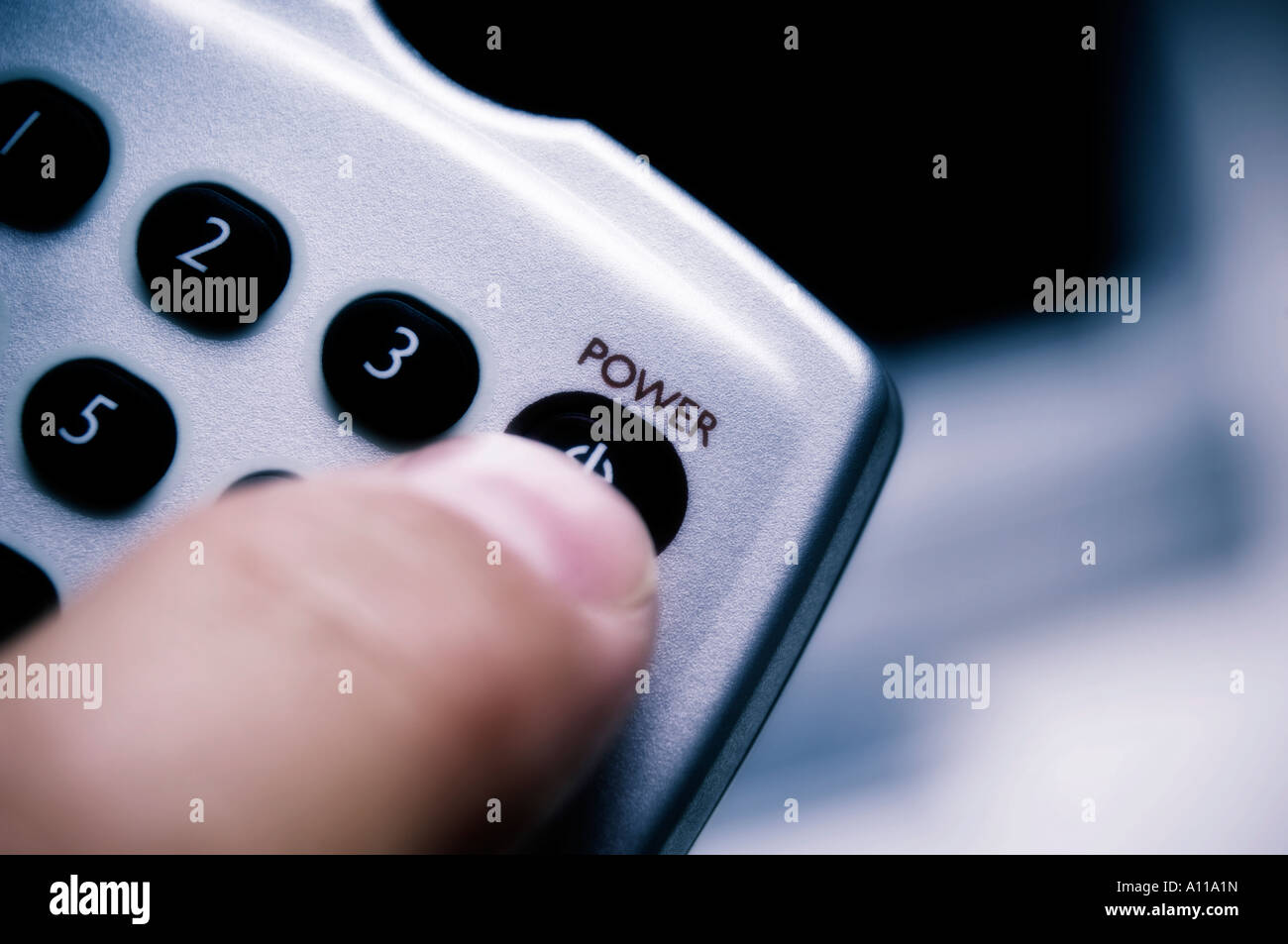 Man changing TV channel with remote control Stock Photo - Alamy