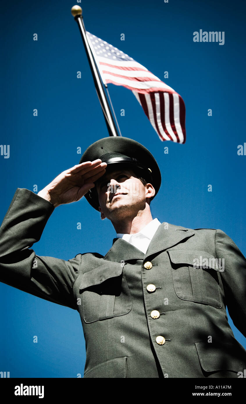 Army personnel saluting american flag hi-res stock photography and ...