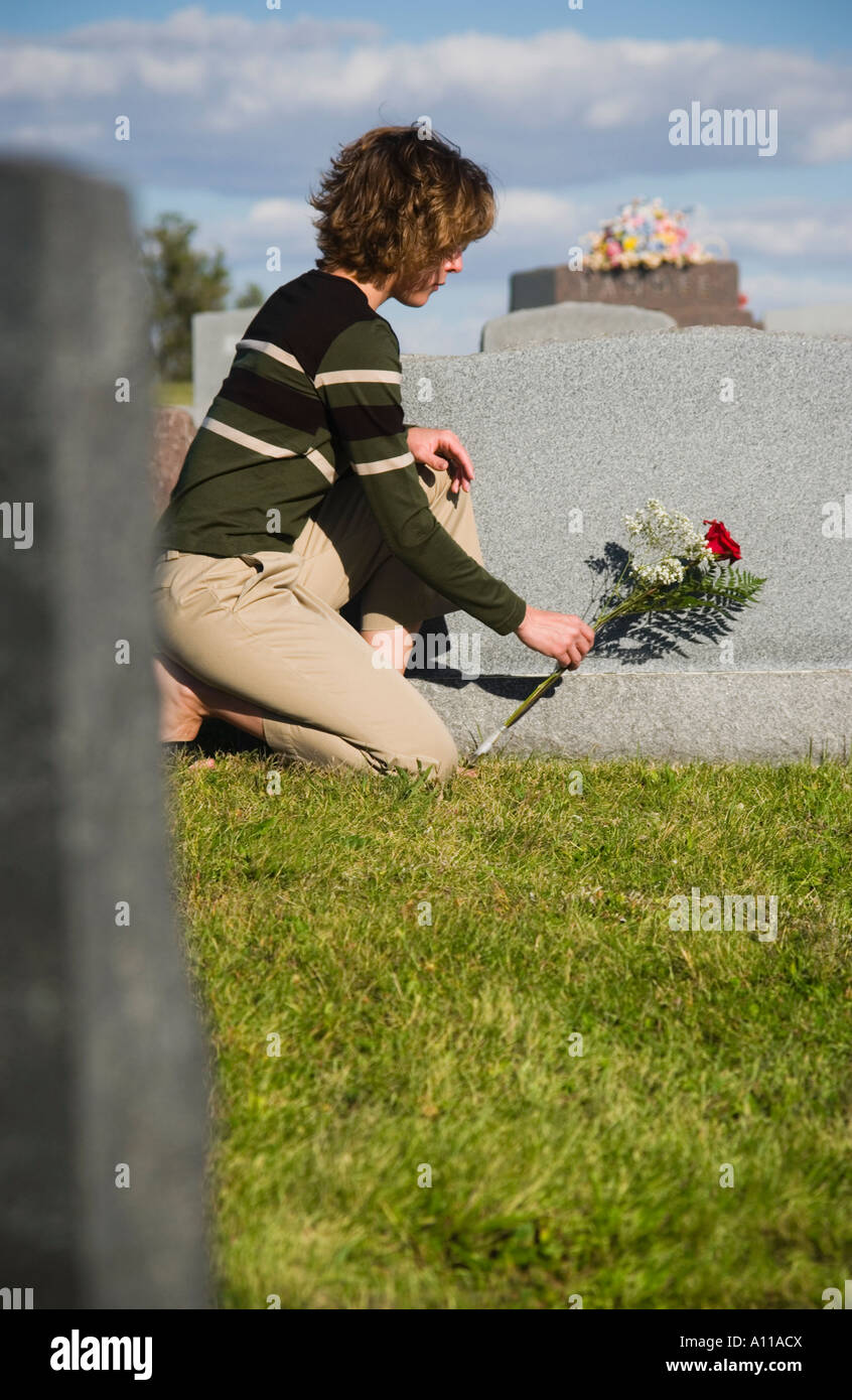 Woman at headstone Stock Photo - Alamy