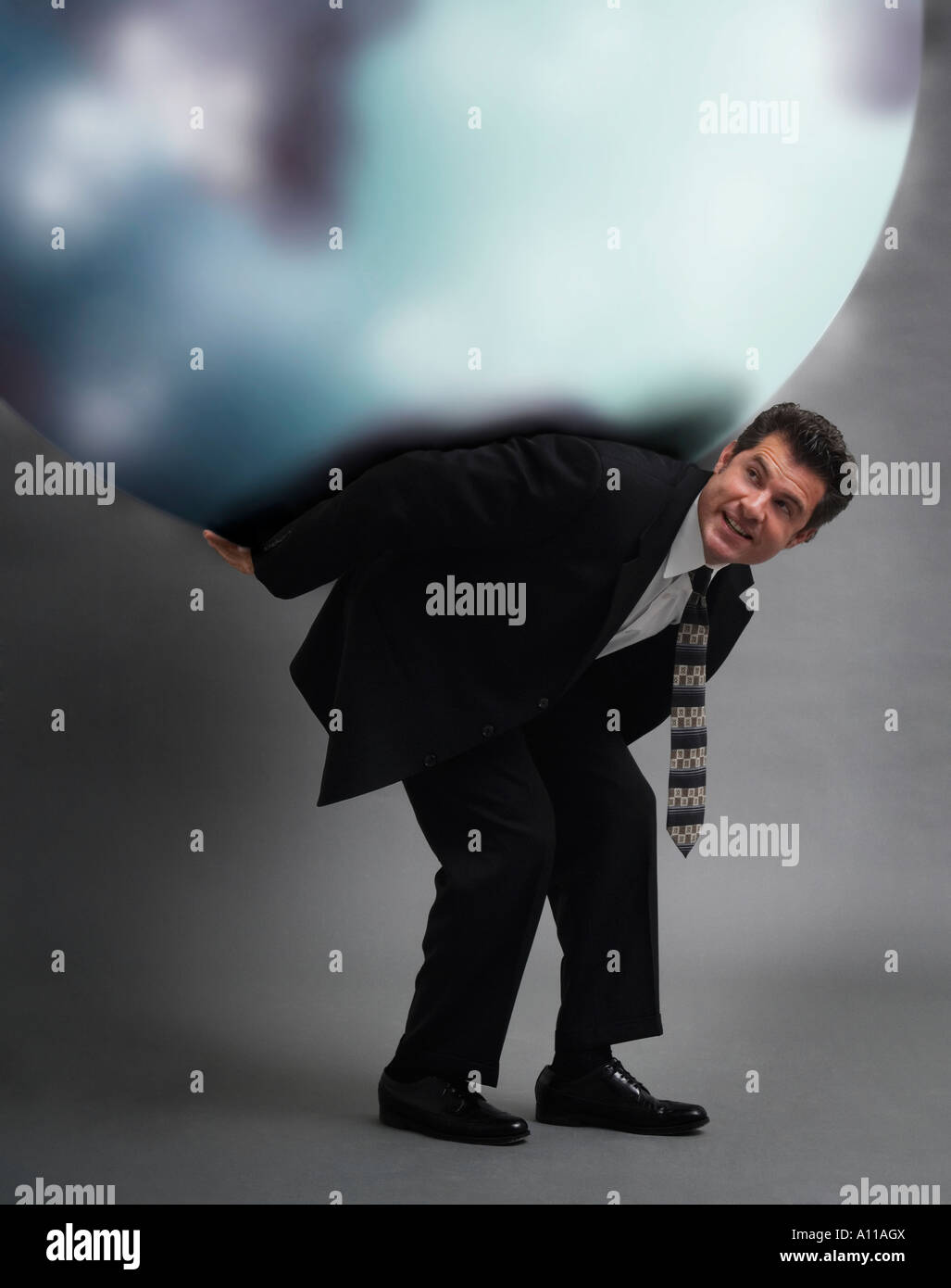 Man carrying the world on his back Stock Photo - Alamy