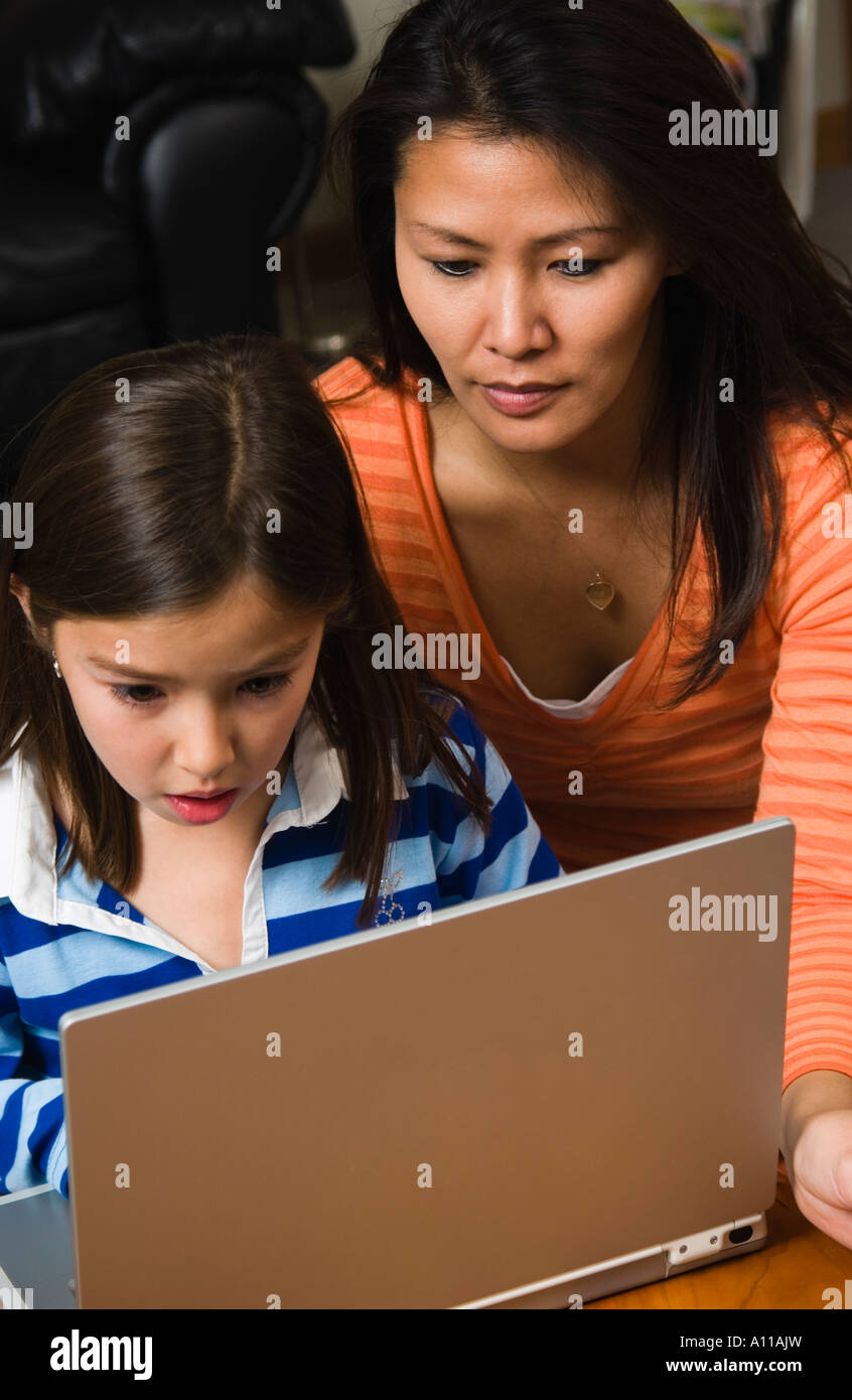 Mom and daughter working on computer Stock Photo - Alamy