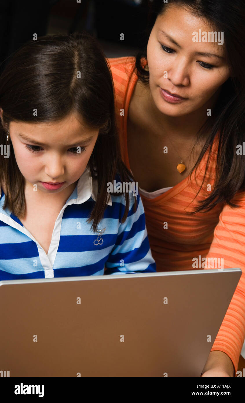 Mom and daughter working on computer Stock Photo - Alamy