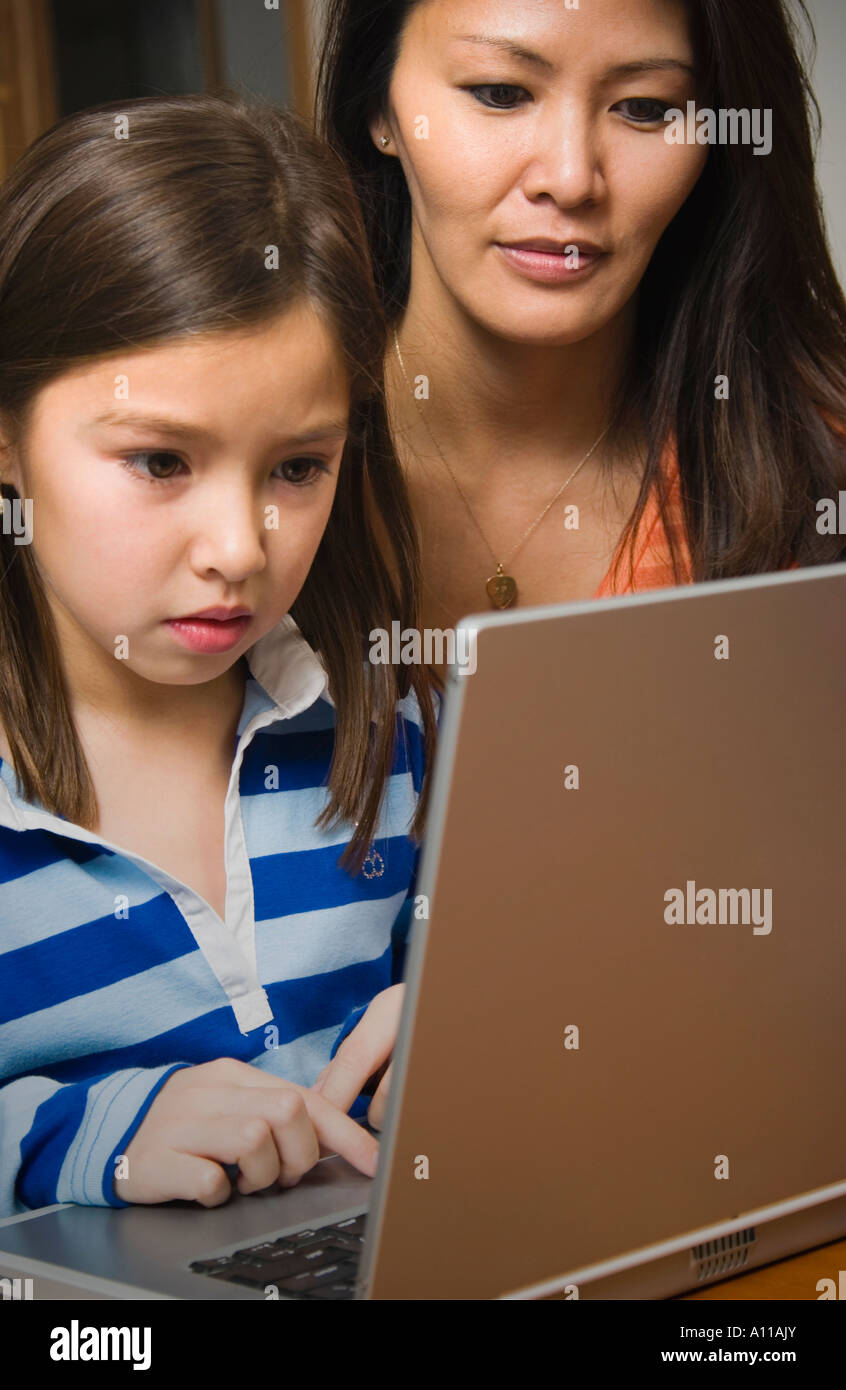 Mom and daughter working on computer Stock Photo - Alamy