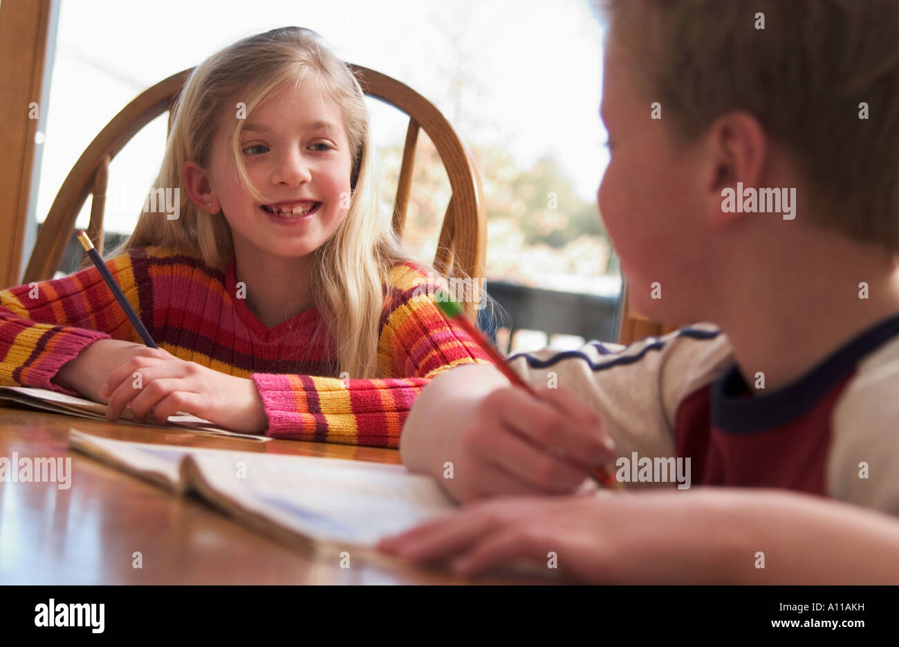 Kids doing homework Stock Photo - Alamy